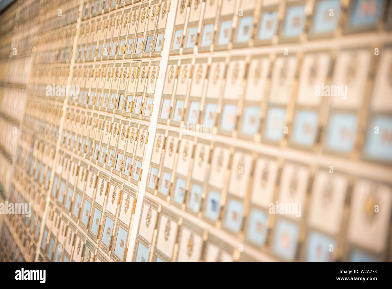 Rows of mid-century modern design post office mailboxes in brass metal ...