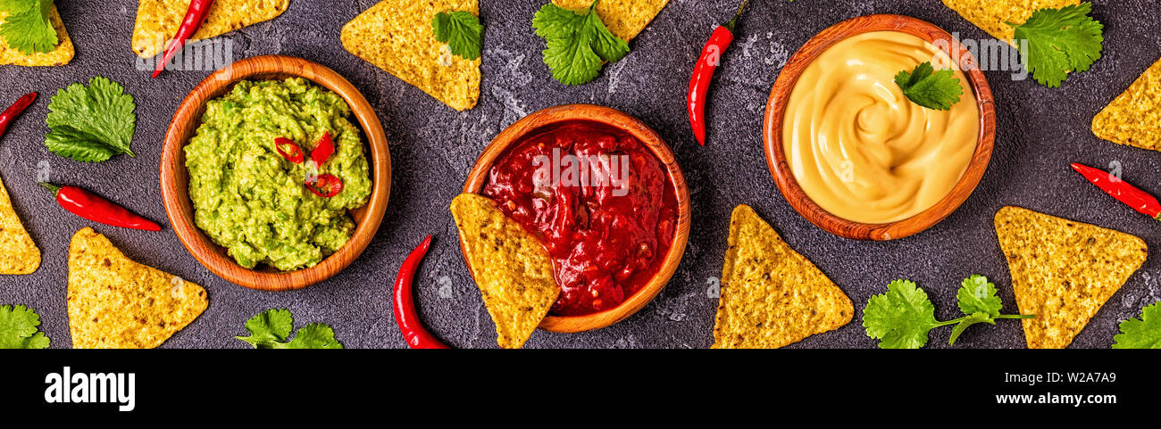 Mexican food background: guacamole, salsa, cheesy sauces with ...