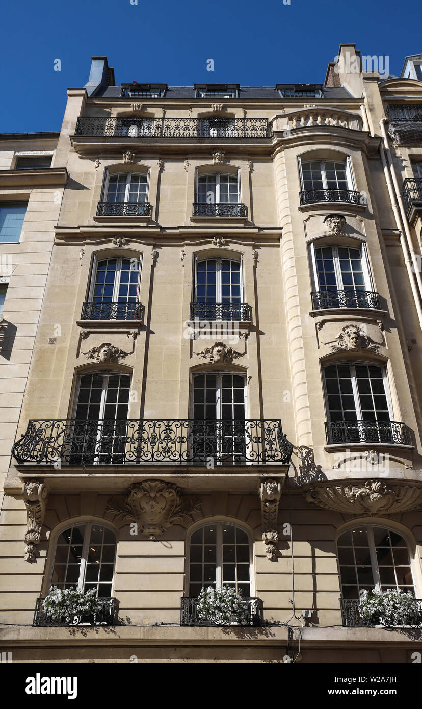 Traditional French house with typical balconies and windows. Paris ...