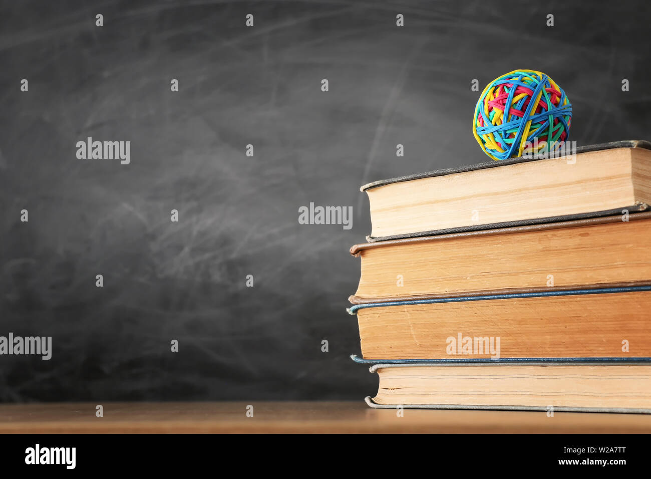 education and back to school concept. stack of books over wooden desk ...