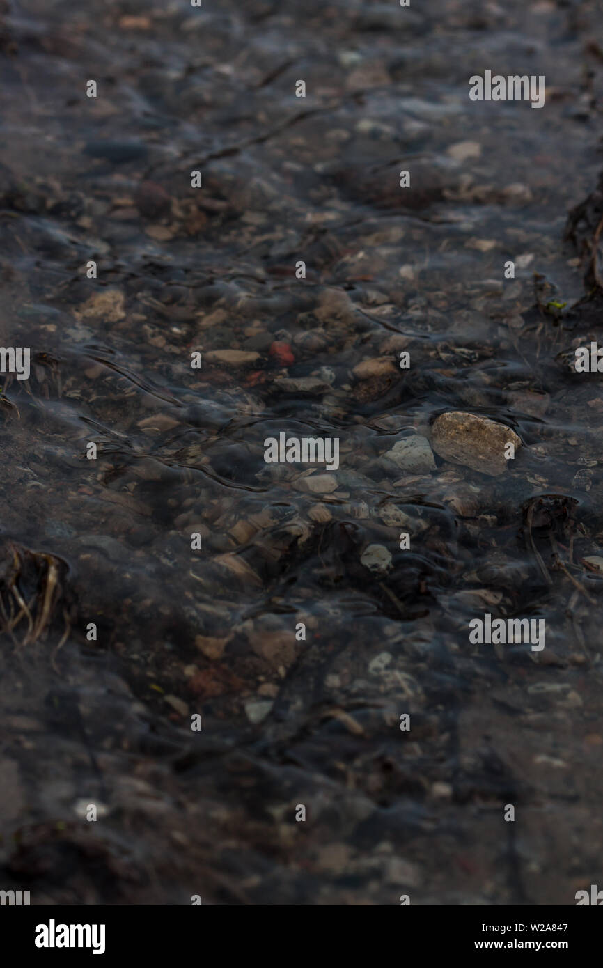 mud in the rain creating mini waterfall and river Stock Photo - Alamy