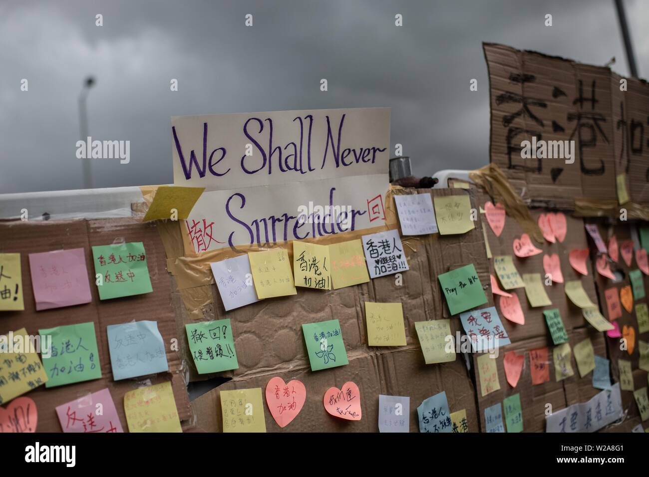 Stickers with different messages from the protesters hang on the wall ...