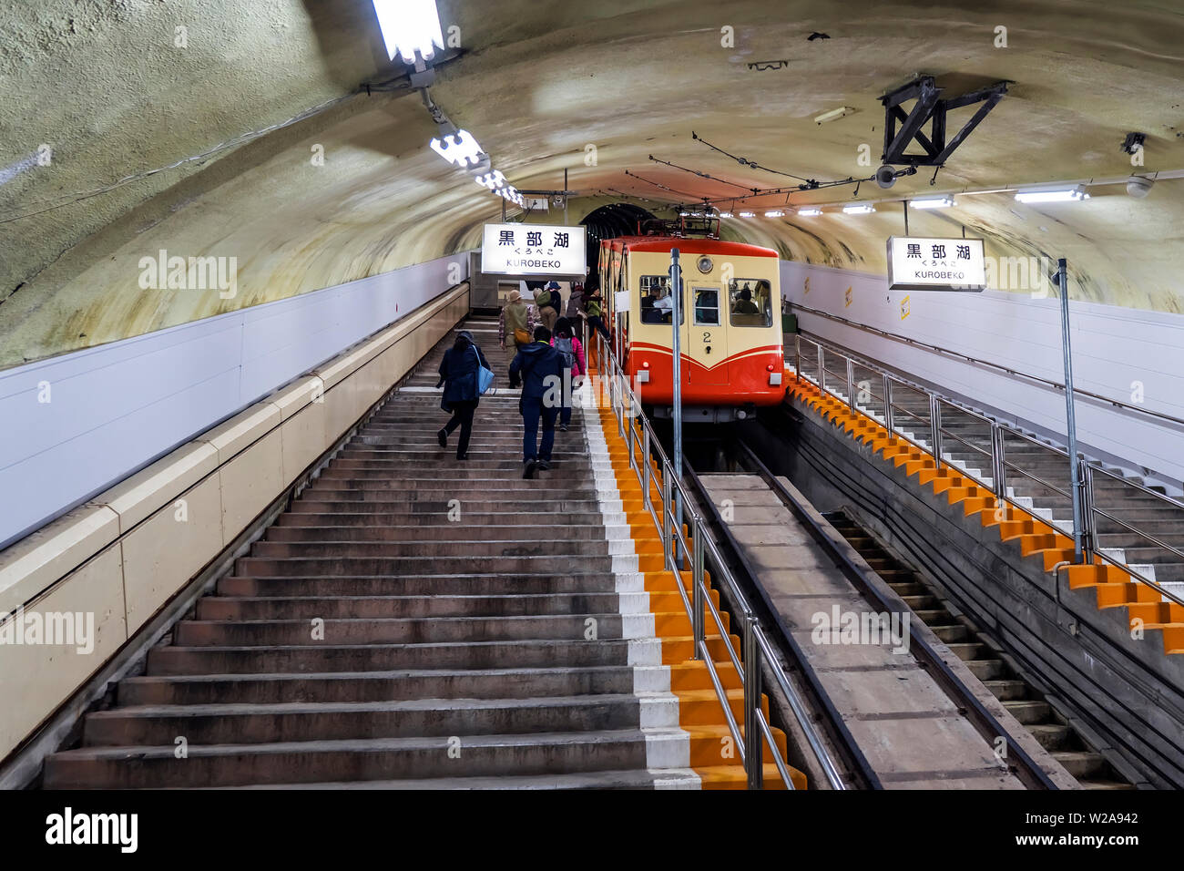 Underground Train On Steep Slope And People Climbing Up The Stair In A ...