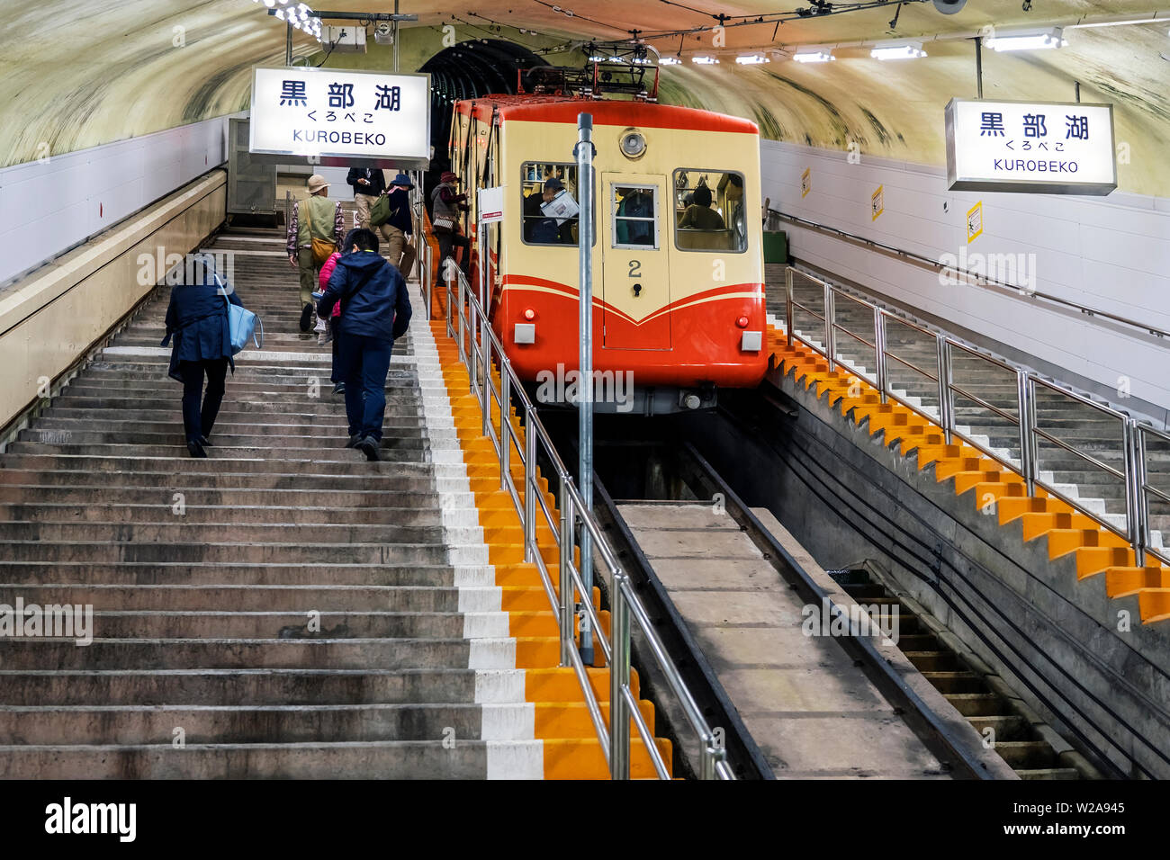 Underground Tram On Steep Slope And People Climbing Up The Stair In A ...