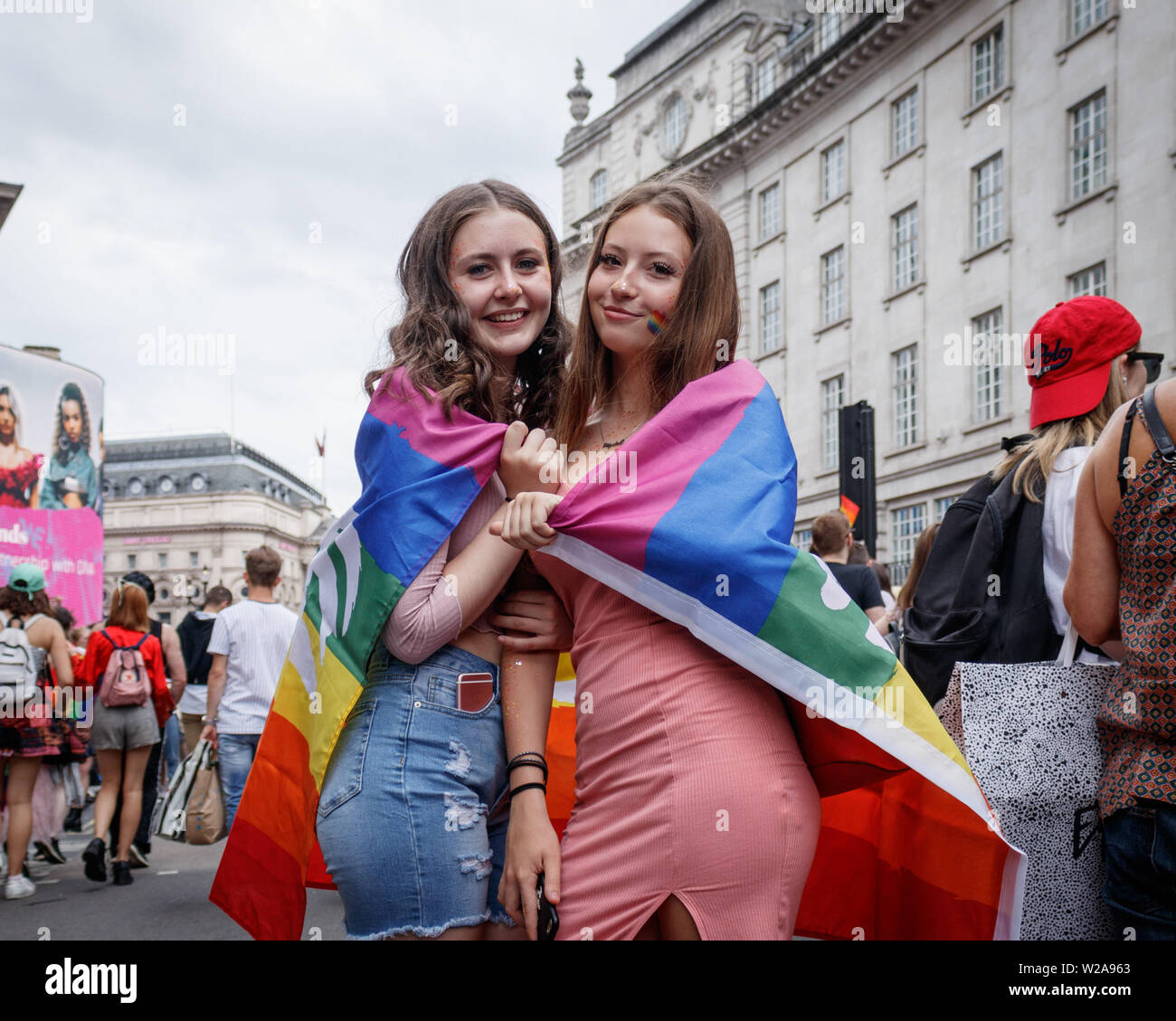 London, England, UK. 6th July, 2019. Women wrapped in a rainbow flag ...