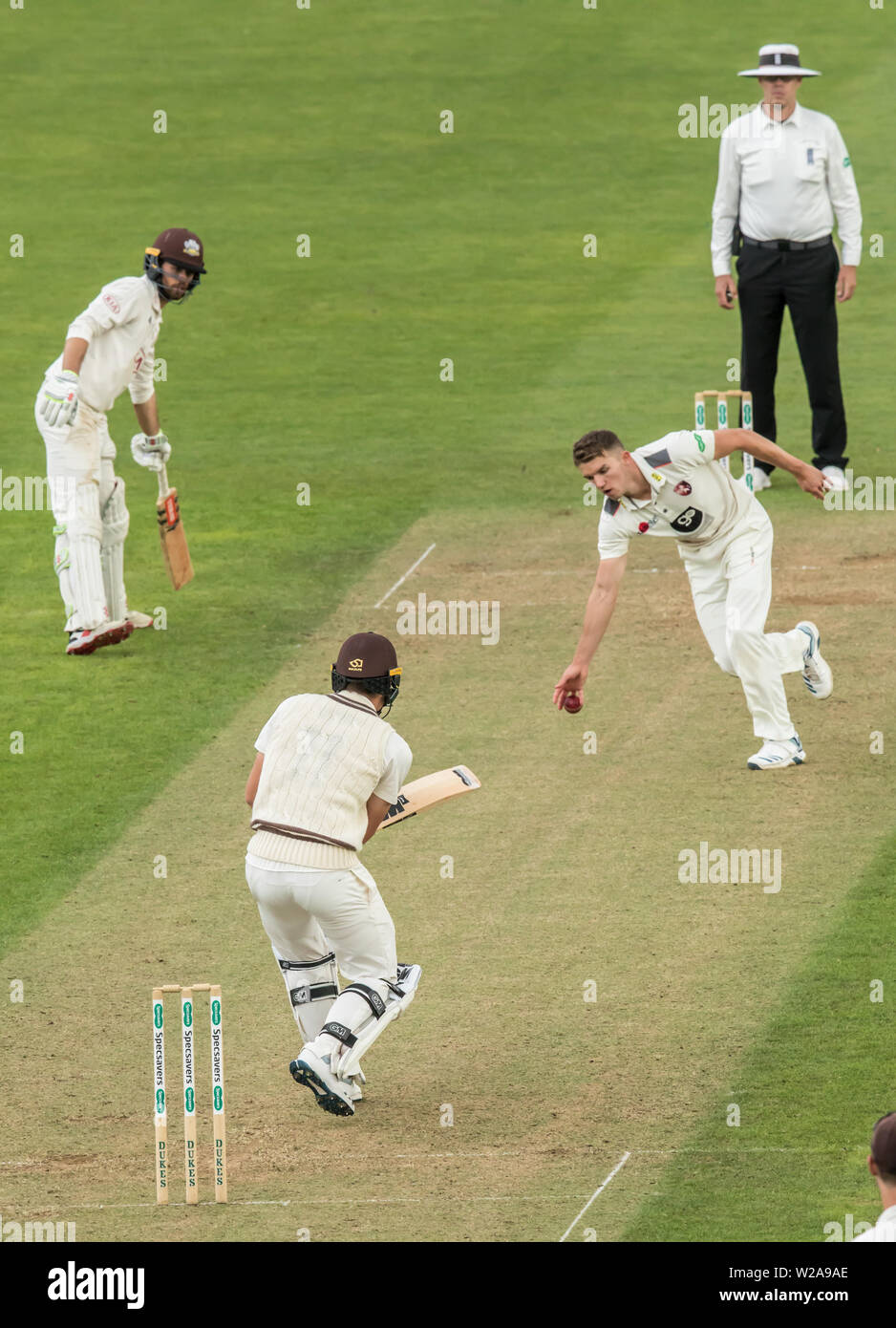 London, UK. 7 July, 2019. Matthew Milnes fields off his own bowling as ...
