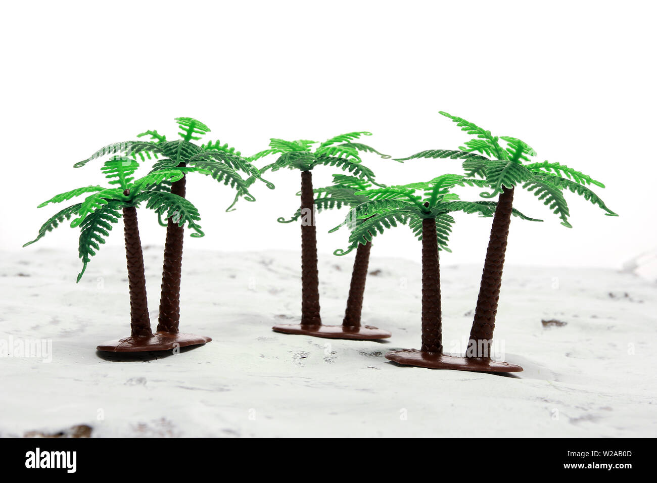 Miniature Palm Trees on Texture Background Stock Photo - Alamy