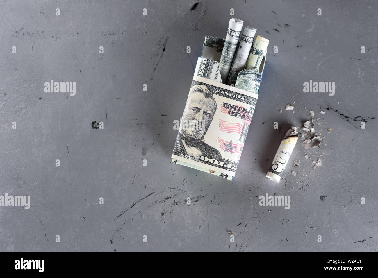 Package of cigarette filled with paper money dollars banknote and ...