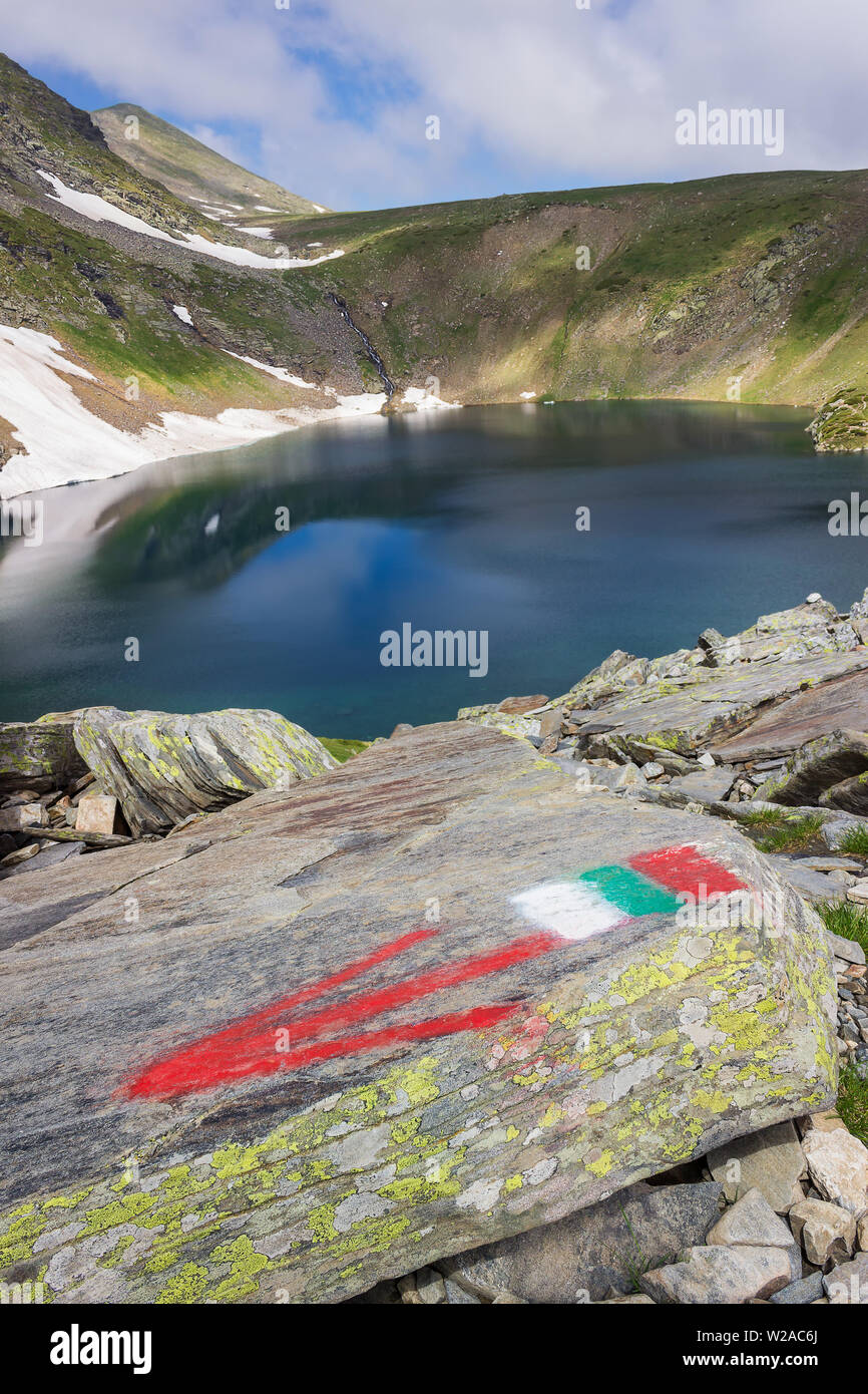 Bulgarian flag and red arrow track marking in front of the Eye lake ...