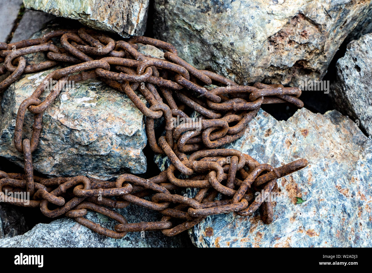 Rusty chain on on gray stones. The symbol of slave labor Stock Photo ...