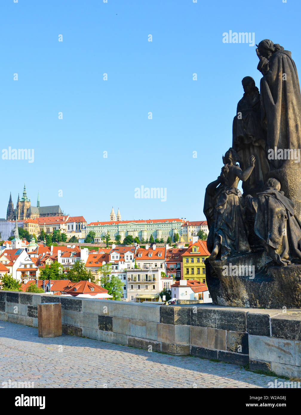 Sculptures on famous Charles Bridge in Prague, Czech Republic with blue ...