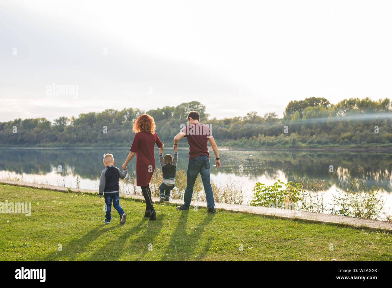 Parent, childhood and nature concept - Family playing with two sons by ...