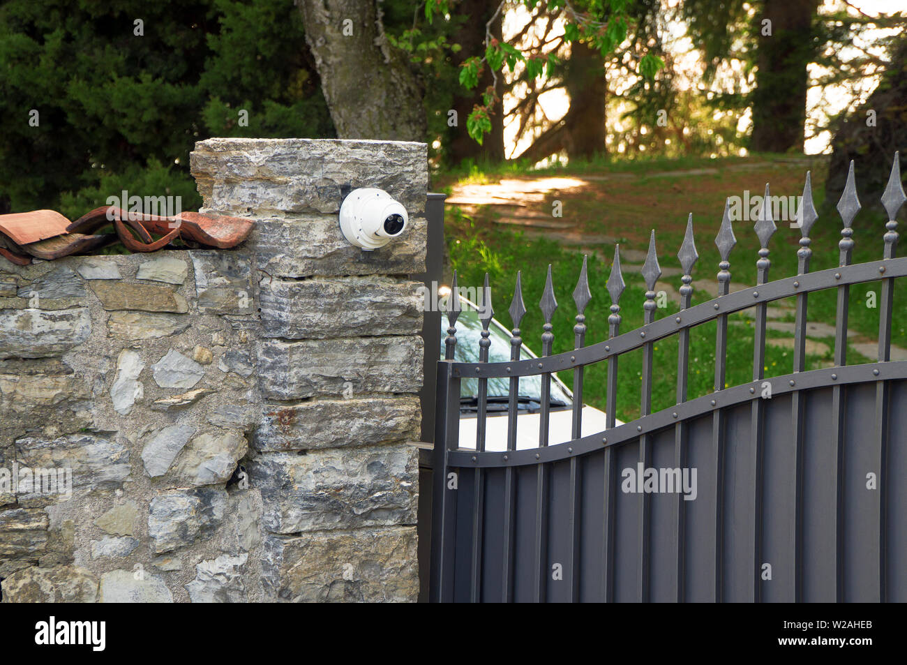 Metal gates and security camera. Concept of private property Stock ...
