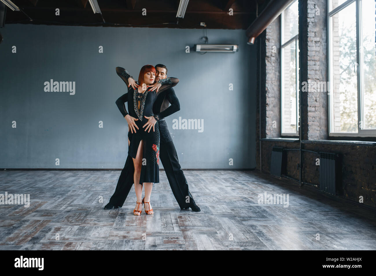 Dancers on ballrom dance training in class. Female and male partners on ...