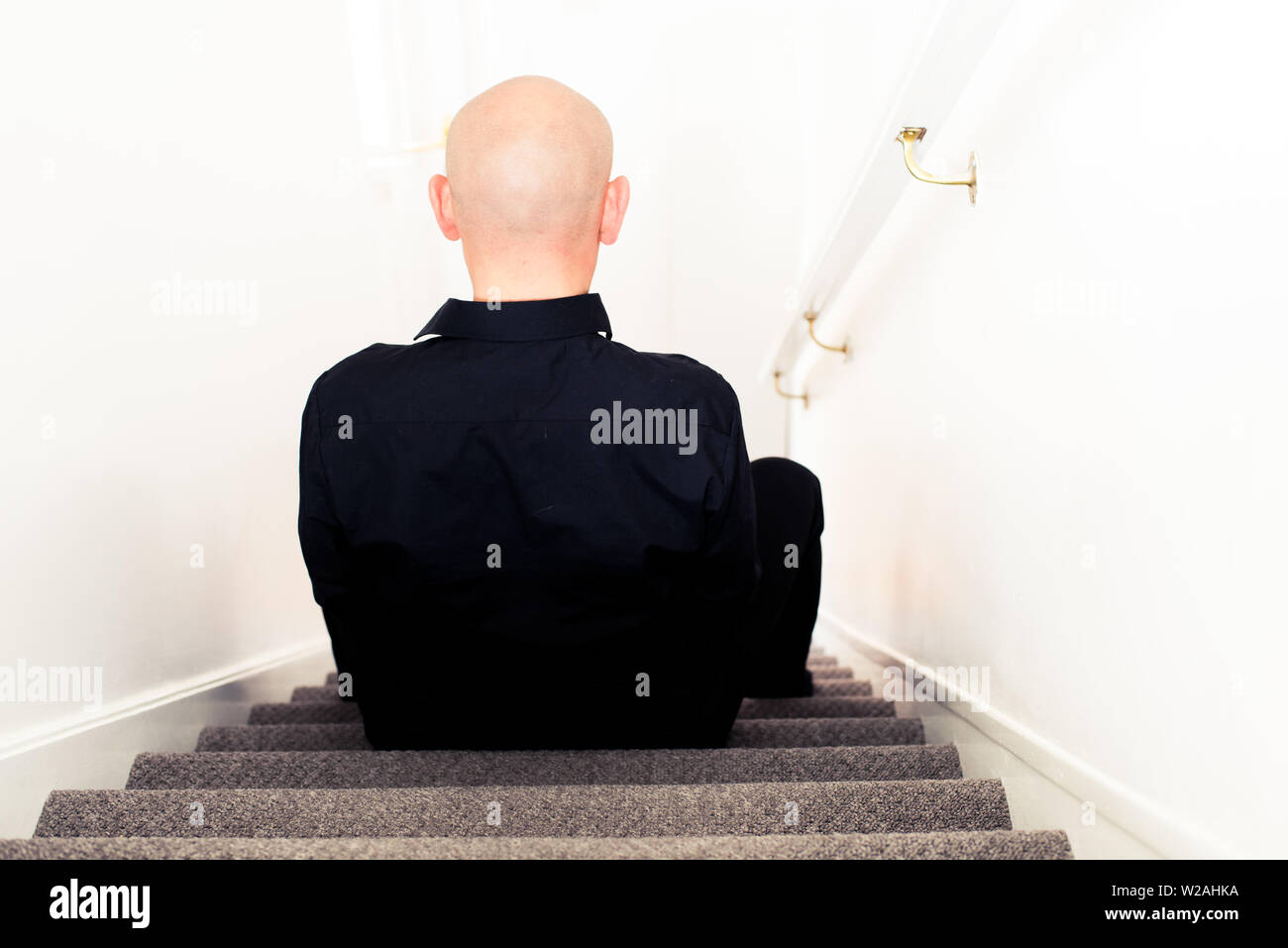 Young depressed man sitting on a floor and crying Stock Photo - Alamy