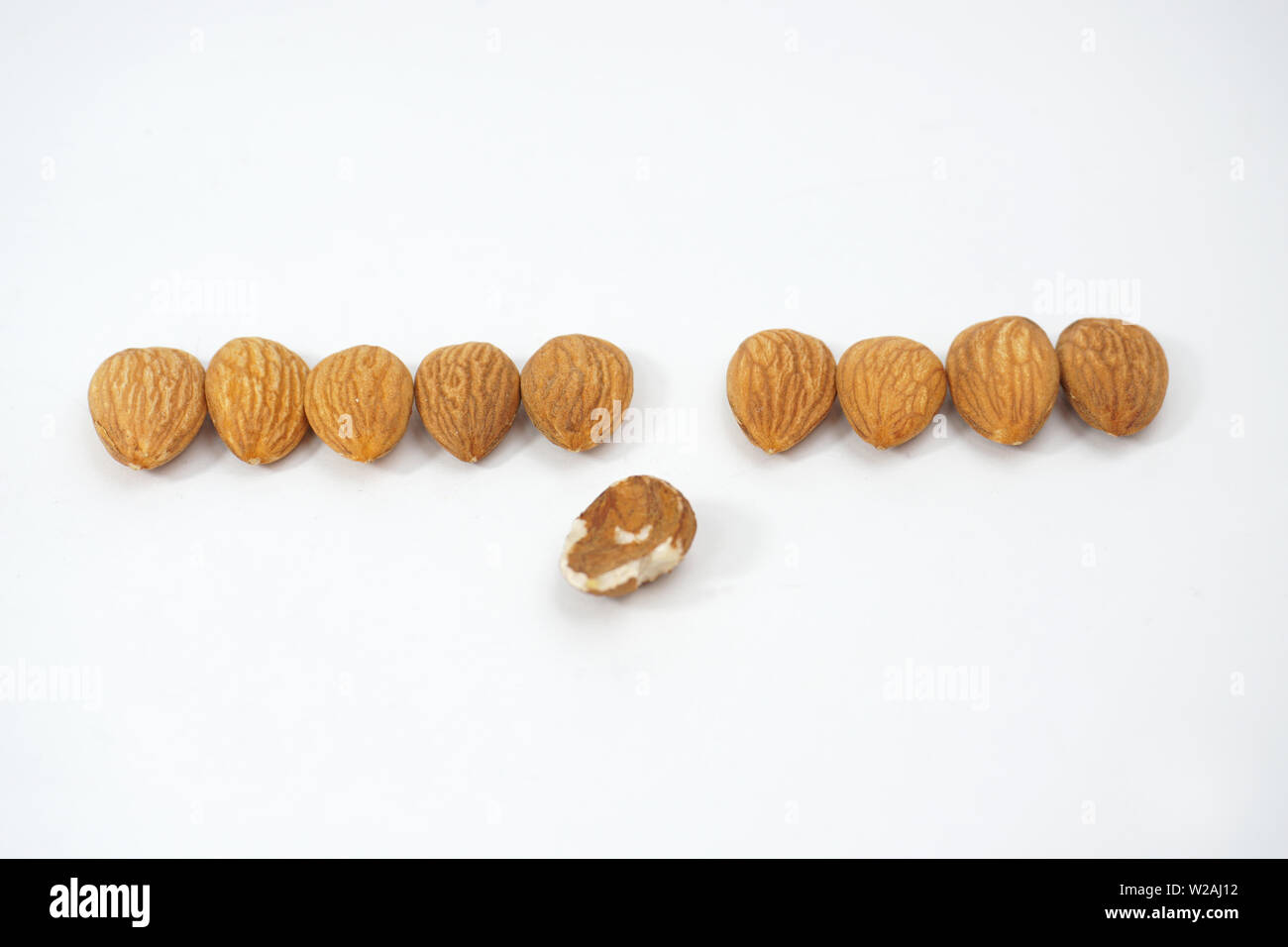 good and bad almonds isolated on white background Stock Photo - Alamy