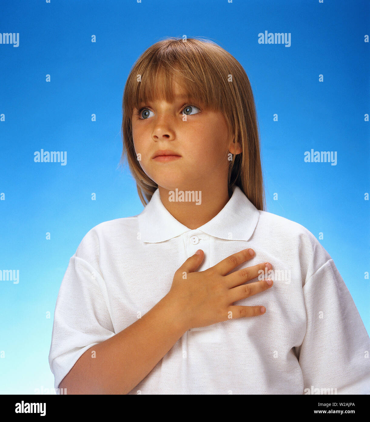 Young Girl Gazing up with her hand on her heart and she says the pledge ...