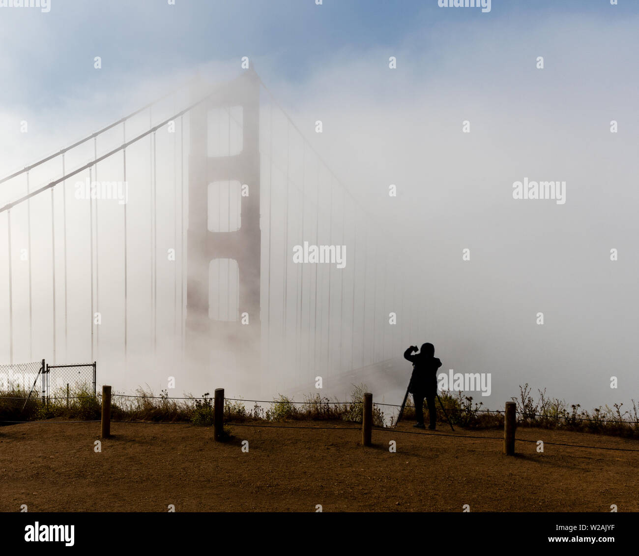The silhouette of unidentified photographer shooting the Golden Gate ...