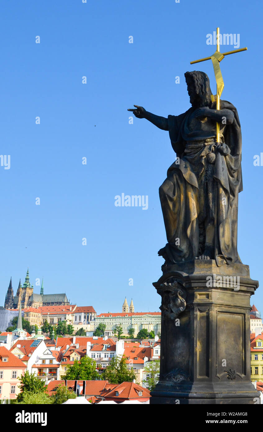 Religious statue pointing finger on famous Charles Bridge in Prague ...
