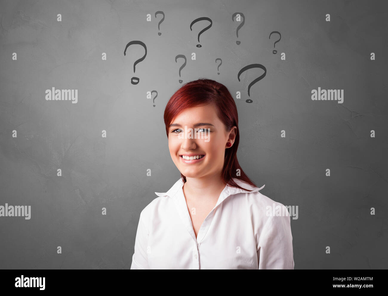 Person with question marks around face Stock Photo - Alamy