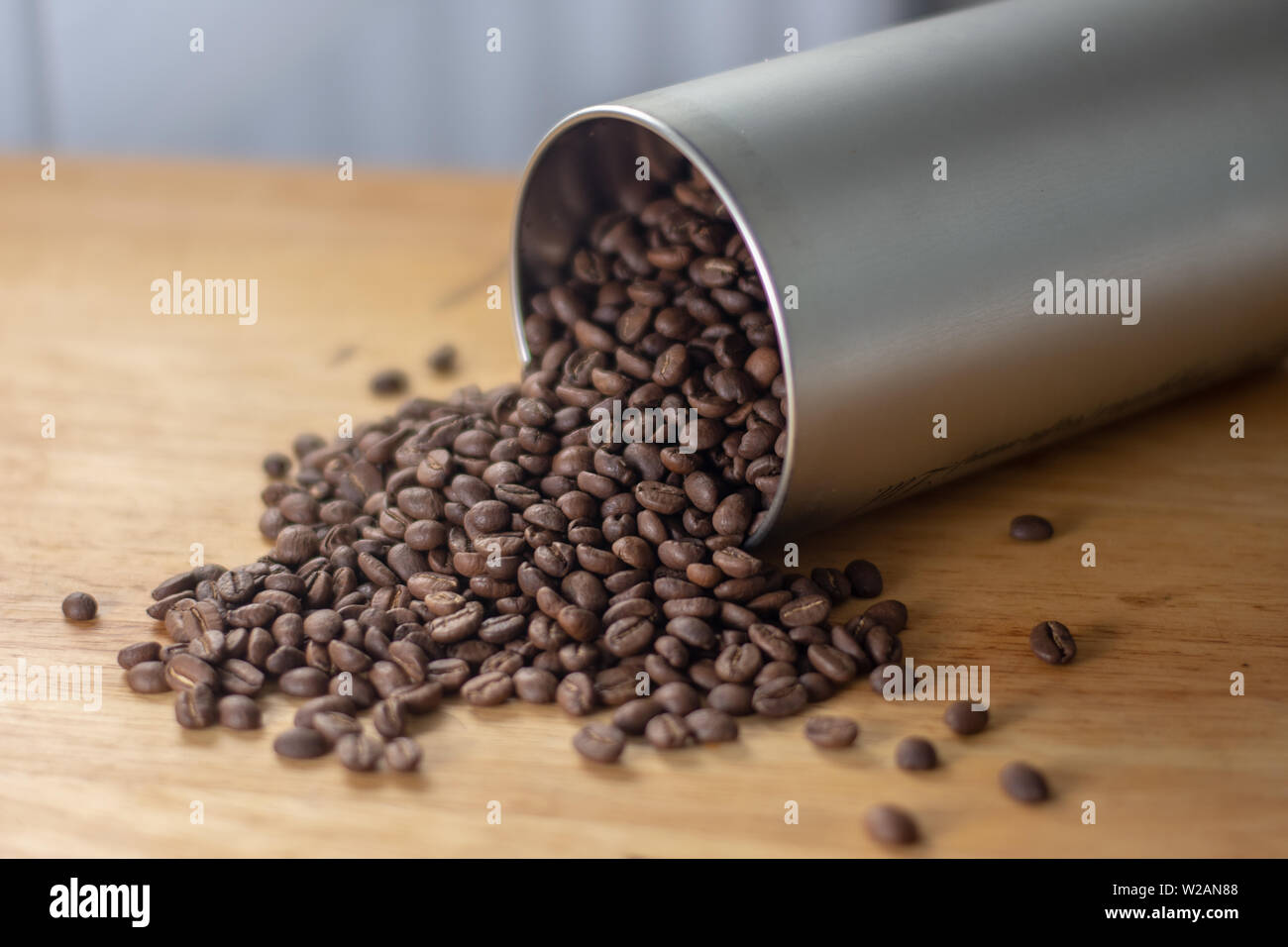 Coffee Beans Spilling out of a Tubular Metal Container Stock Photo - Alamy