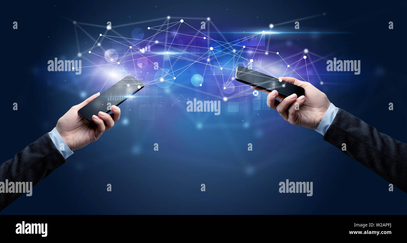 Close up of two hands holding smartphones and sharing business data ...