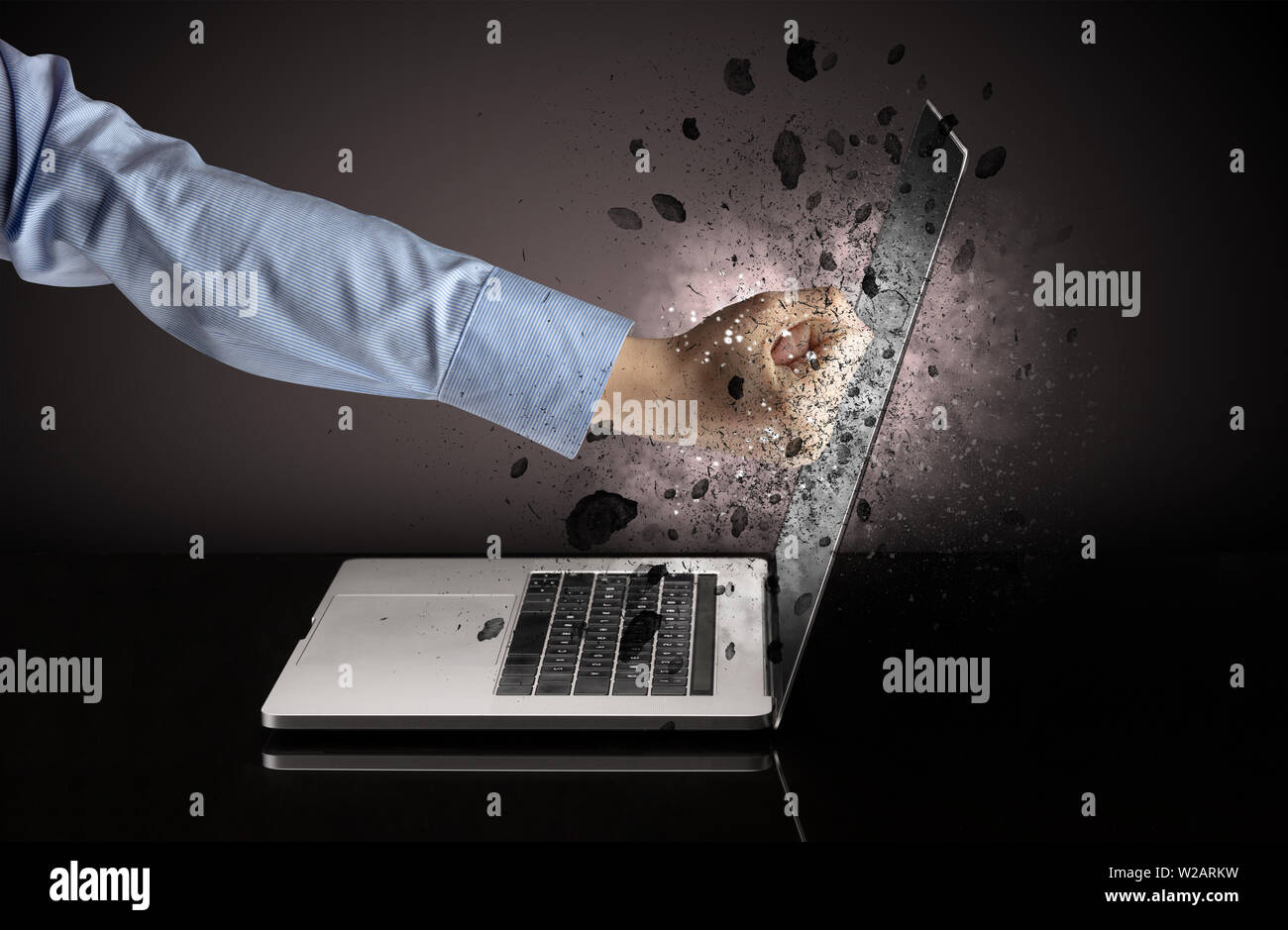 Strong male hand breaks laptop screen glasses Stock Photo - Alamy