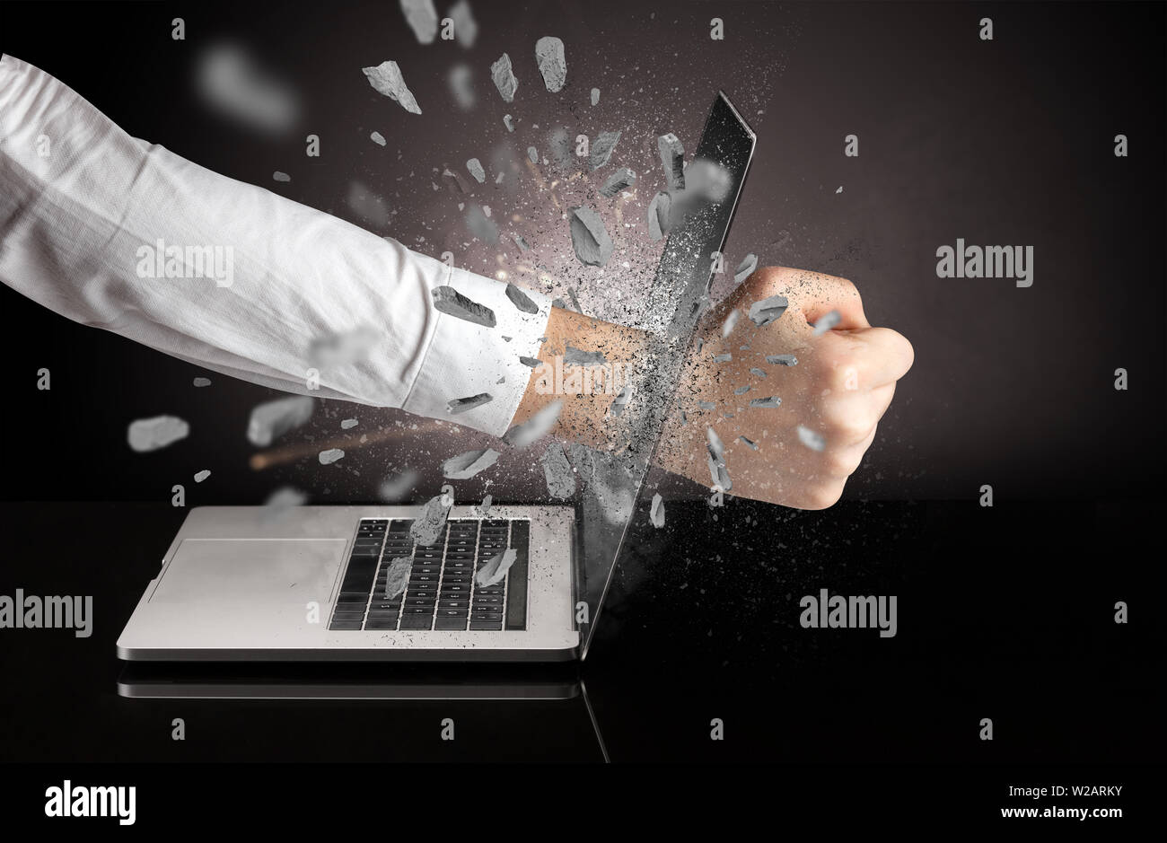 Strong male hand breaks laptop screen Stock Photo - Alamy