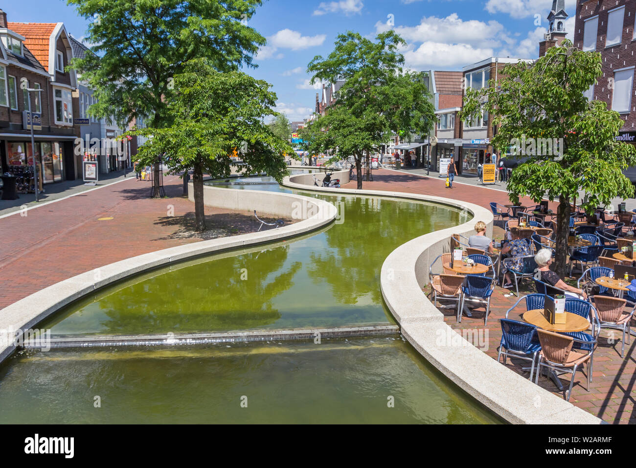 People enjoying the sun at the meandering canal of Hoogeveen ...