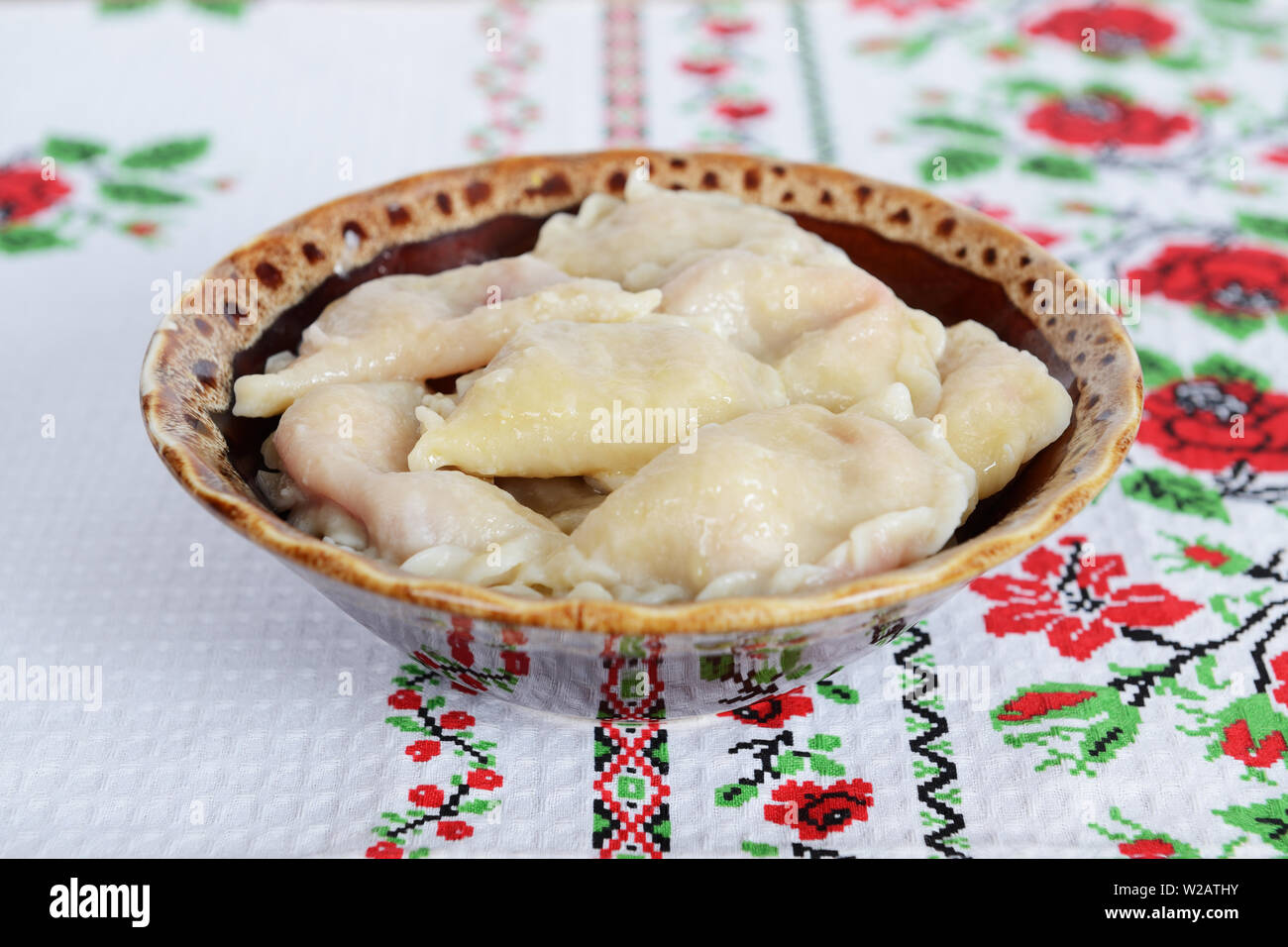 The cooked traditional Ukrainian hand-made vareniki (dumpling) with ...
