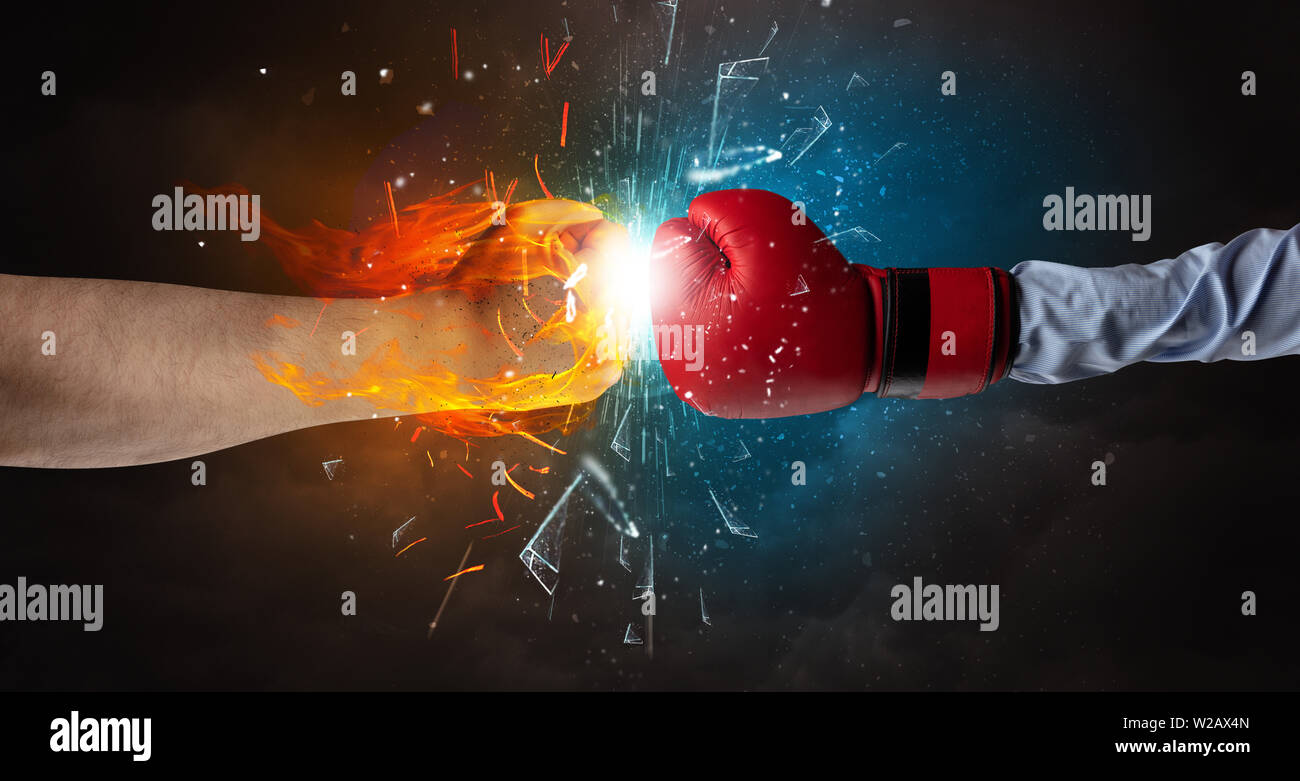 Two hands fighting and breaking glass into small pieces with fire and ...