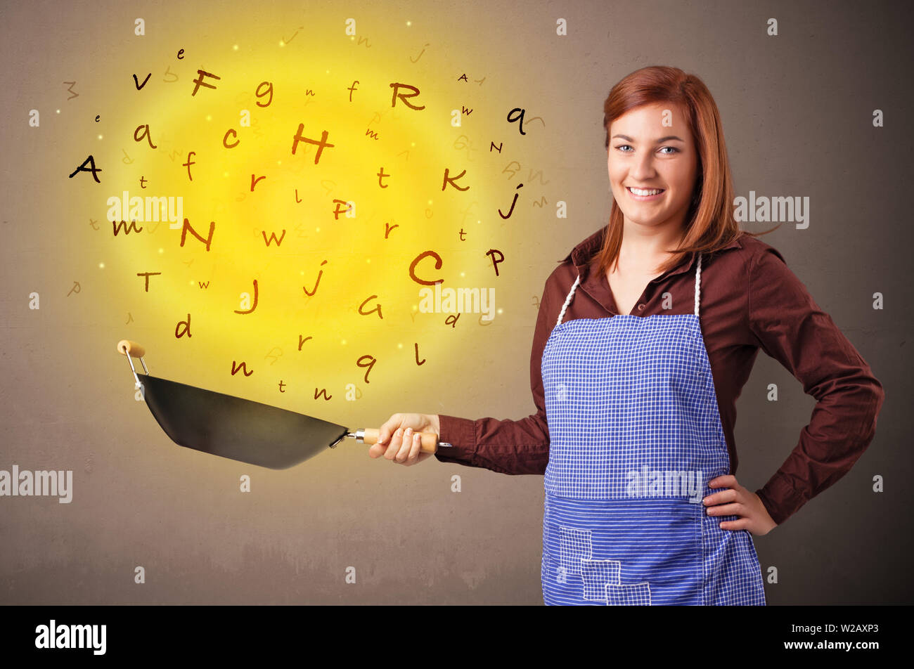 Young person cooking letters in wok Stock Photo - Alamy