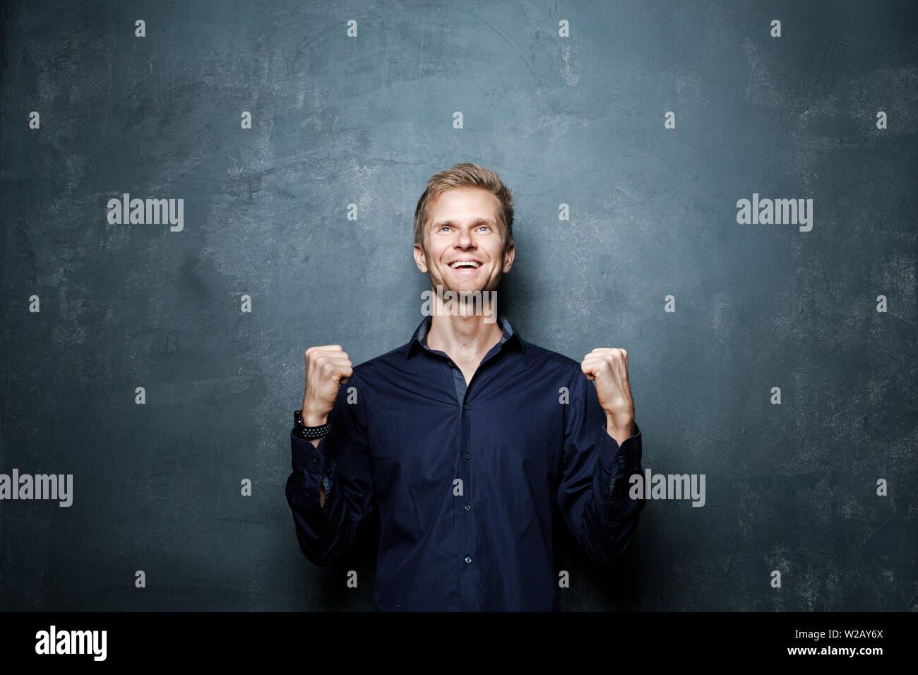 A young man shout out loud on black background Stock Photo - Alamy