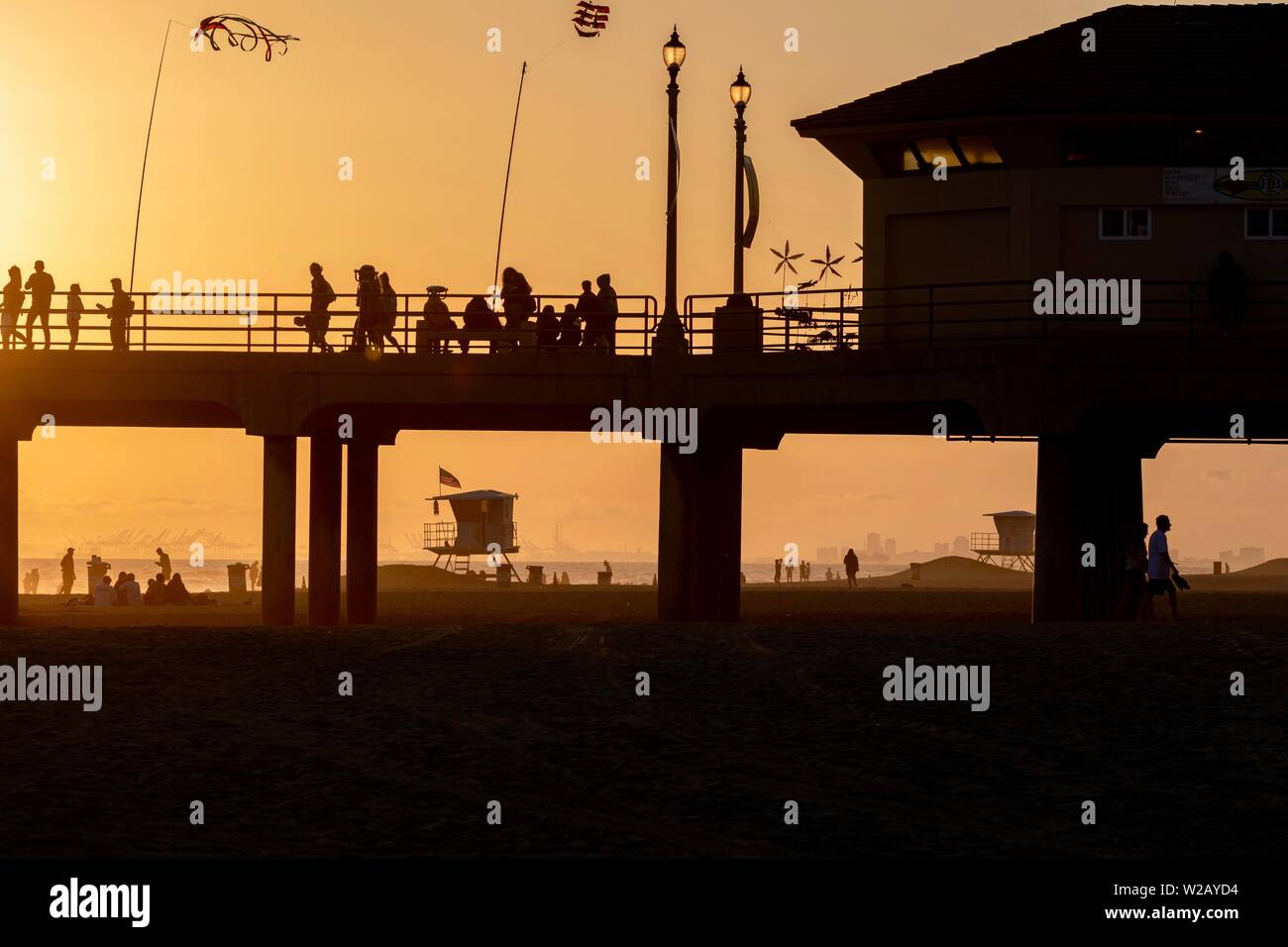 silhouettes of people on the Huntington Beach Pier during sunset Stock ...