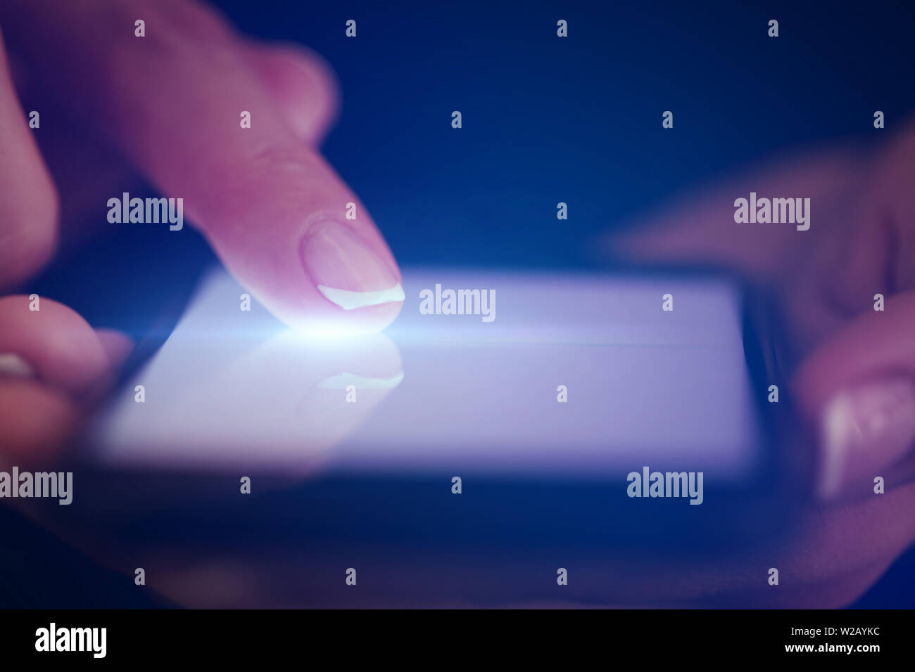 Finger touching phone with dark background with copyspace Stock Photo ...