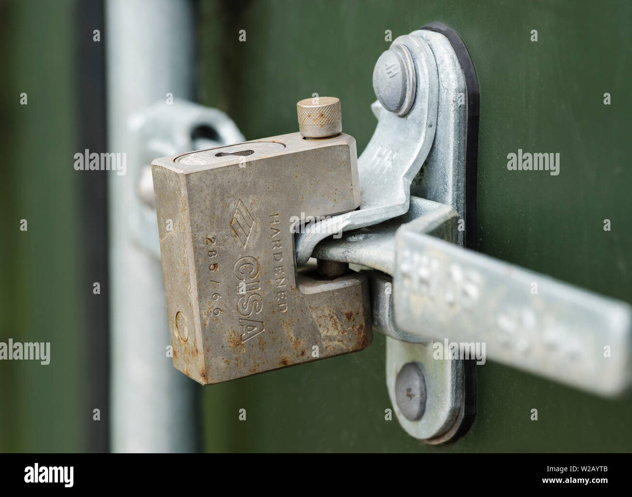 A heavy duty padlock securing a lever to open a shipping container ...