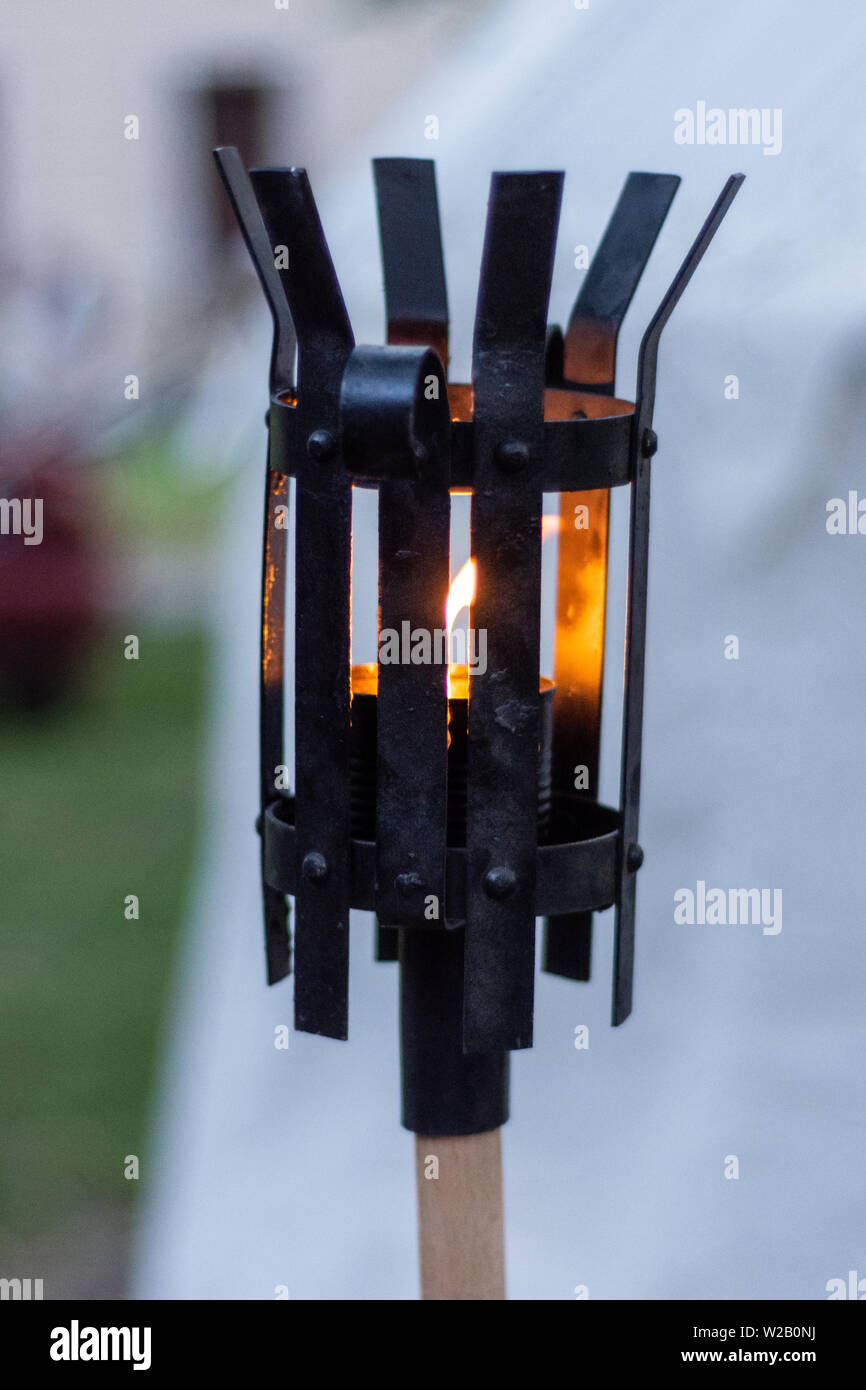 Medieval metal lantern burning in the night. Black iron lamp with the ...