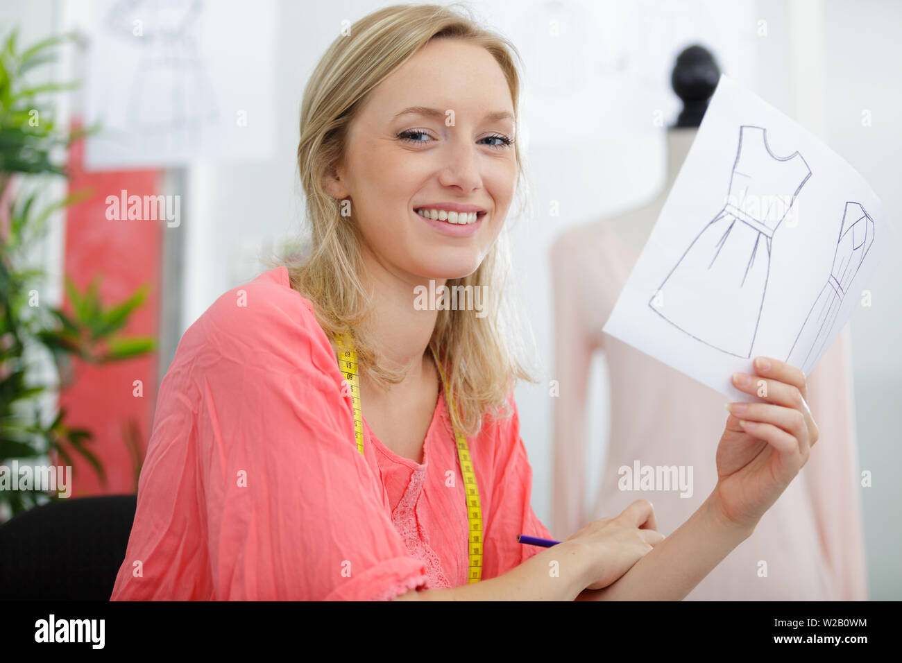 female fashion designers drawing sketches for clothes Stock Photo - Alamy