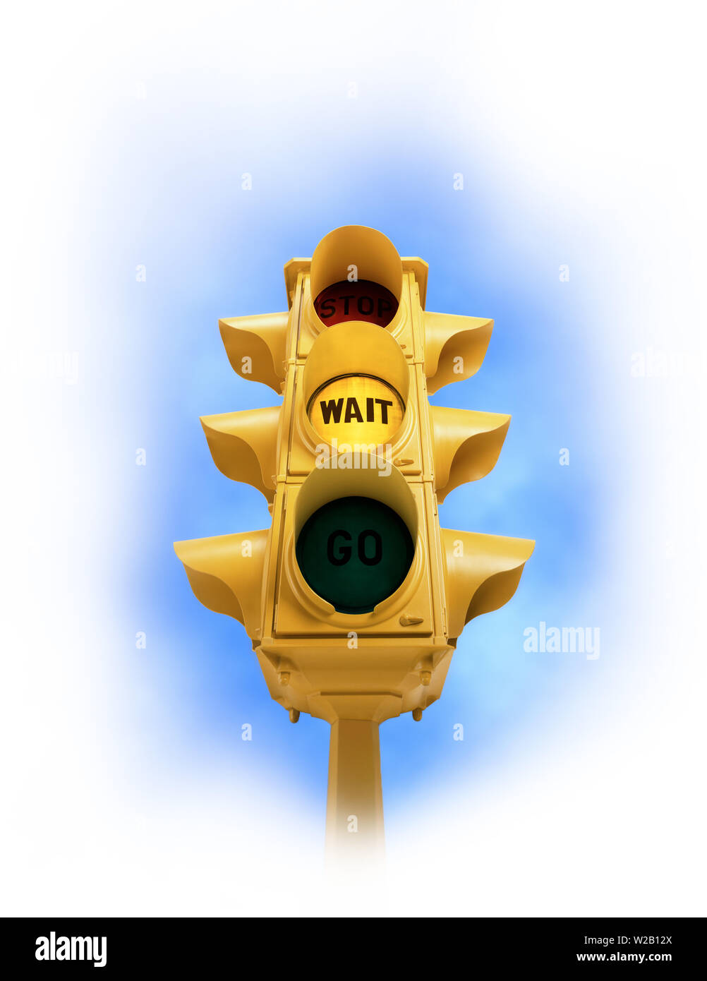 Upward view of tall vintage yellow traffic signal with yellow WAIT ...
