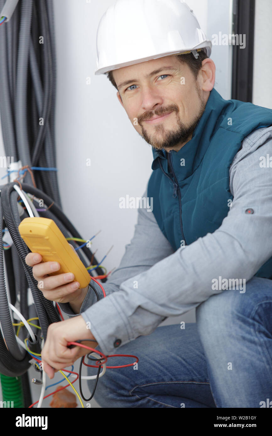 portrait of a young electrician using a multimeter Stock Photo - Alamy