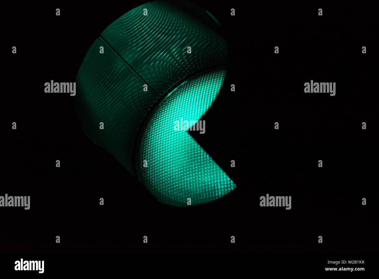 Green illuminated street light at night with black background Stock ...