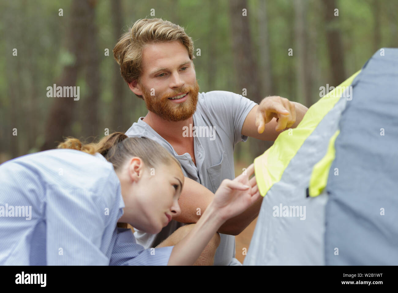 a nice couple sets up a tent Stock Photo - Alamy