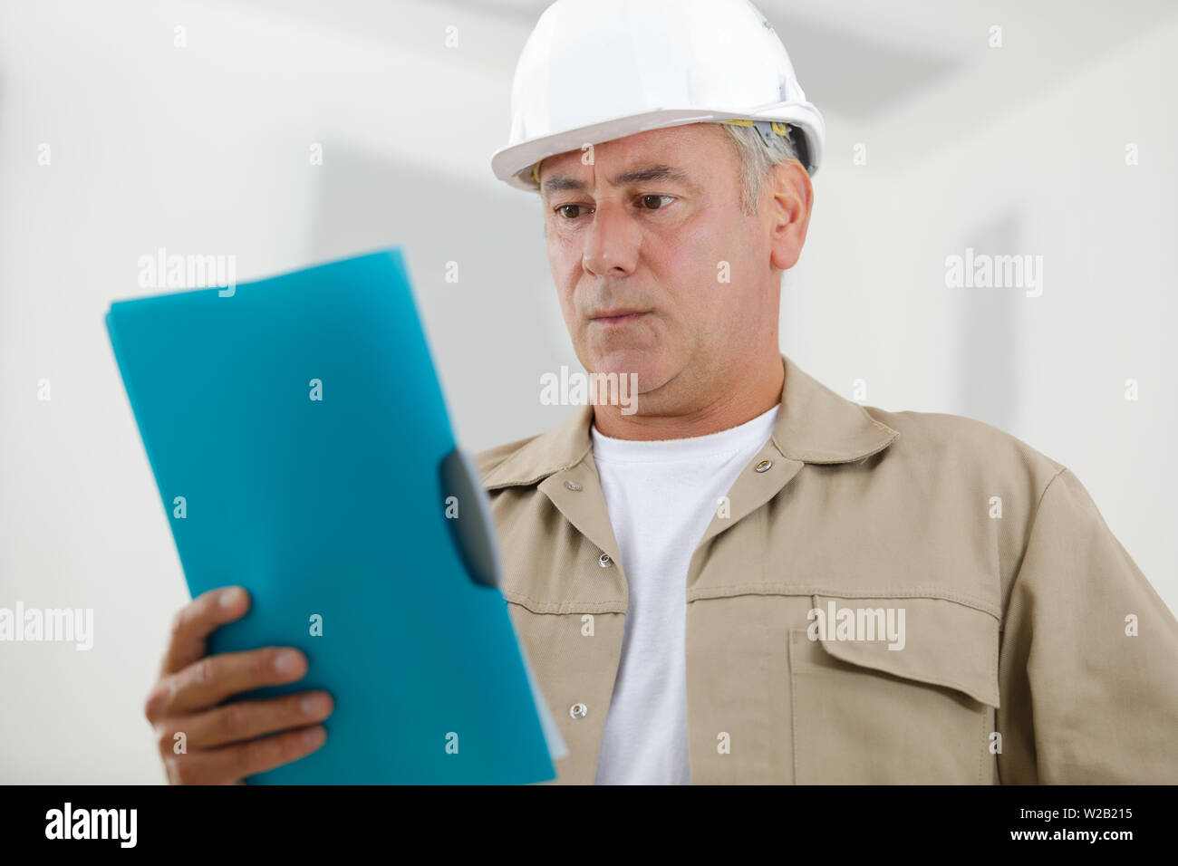 Portrait foreman looking documents hi-res stock photography and images ...