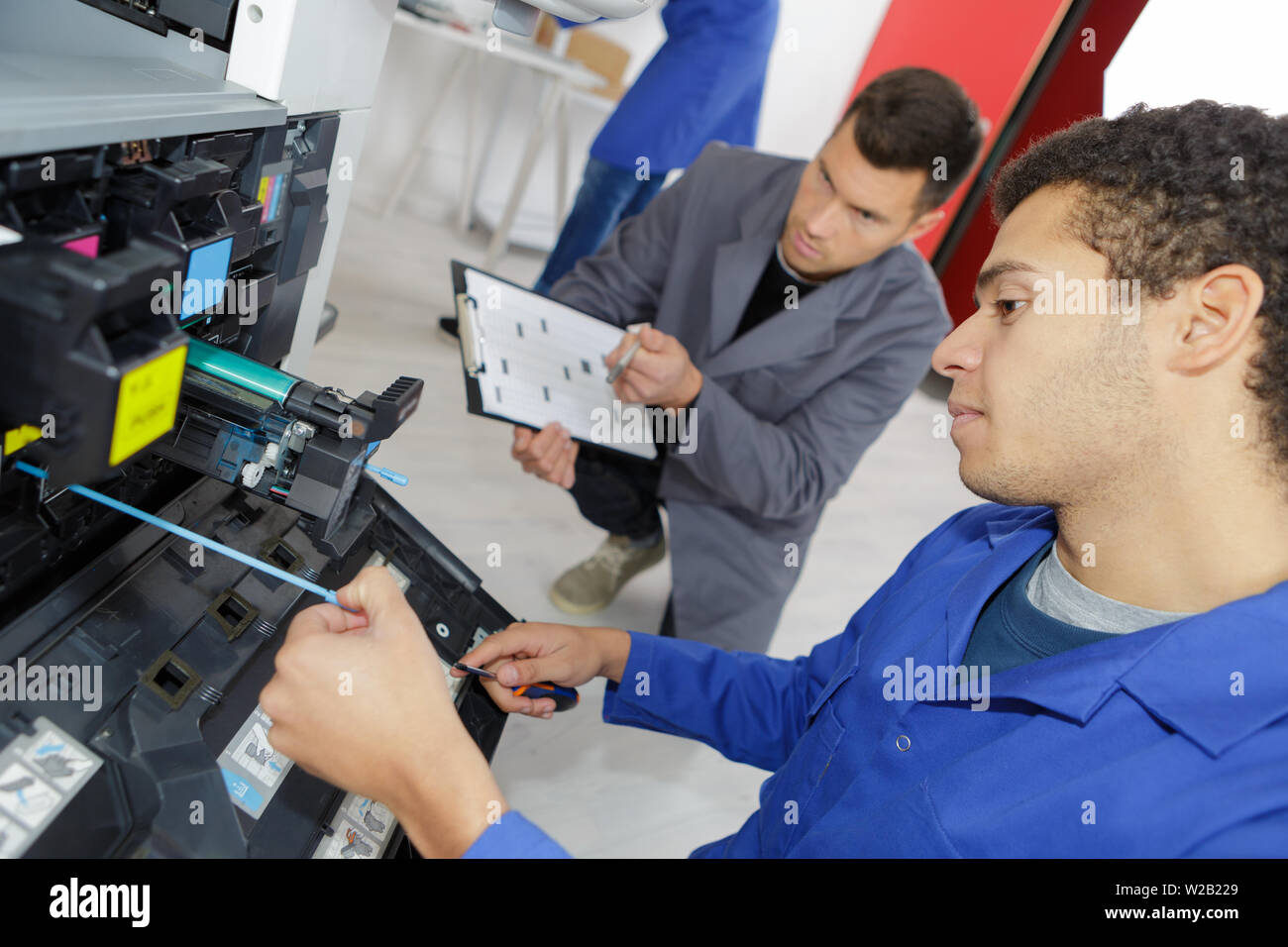 man repairing printer in professional school Stock Photo - Alamy