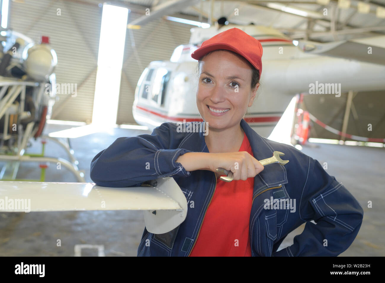 modern woman working in engineering standing by jet plane Stock Photo ...