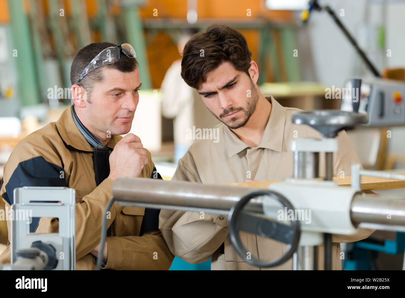 engineer training apprentices on machine Stock Photo - Alamy