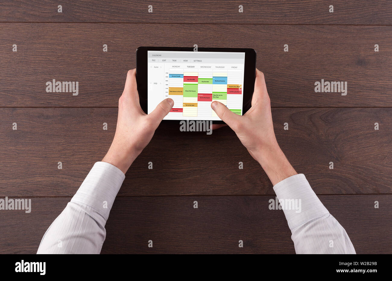 Hand holding tablet with timetable and calendar concept Stock Photo - Alamy
