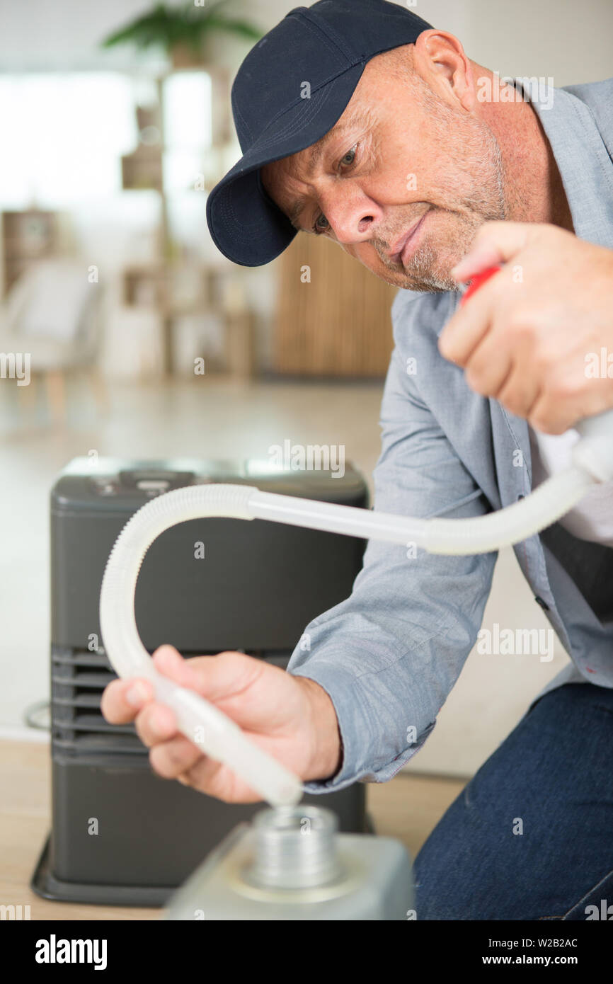 fixing an oil heater at home Stock Photo - Alamy