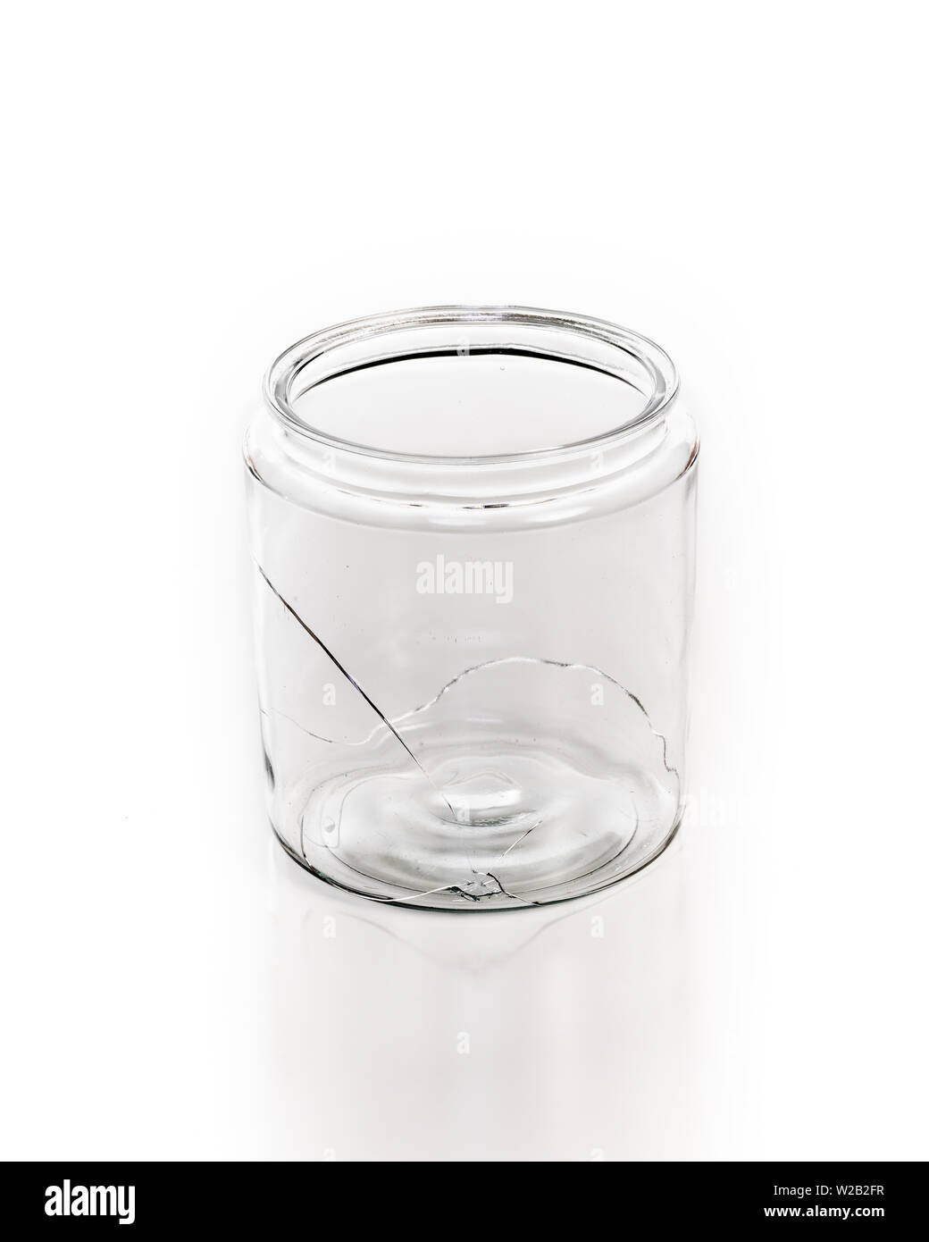 Broken glass container on a white background Stock Photo - Alamy