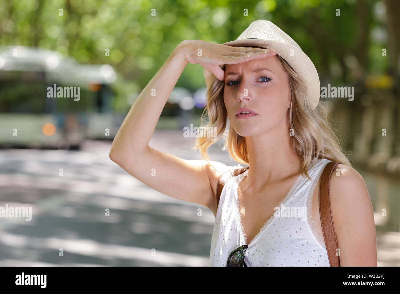 young woman looking into distance shading eyes from the sun Stock Photo ...